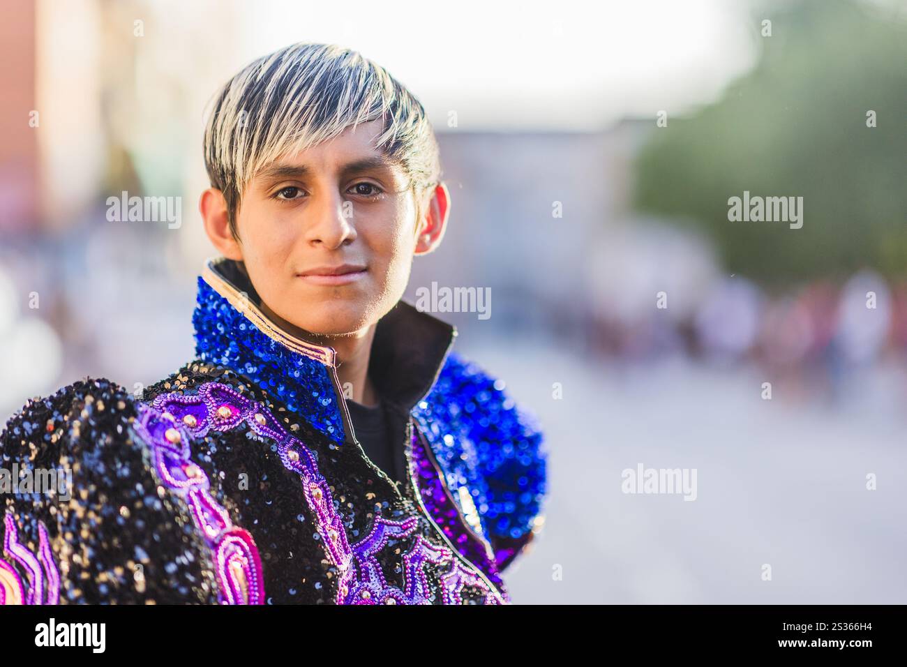 Portrait of a young dancer wearing a colorful costume during a hispanic ...