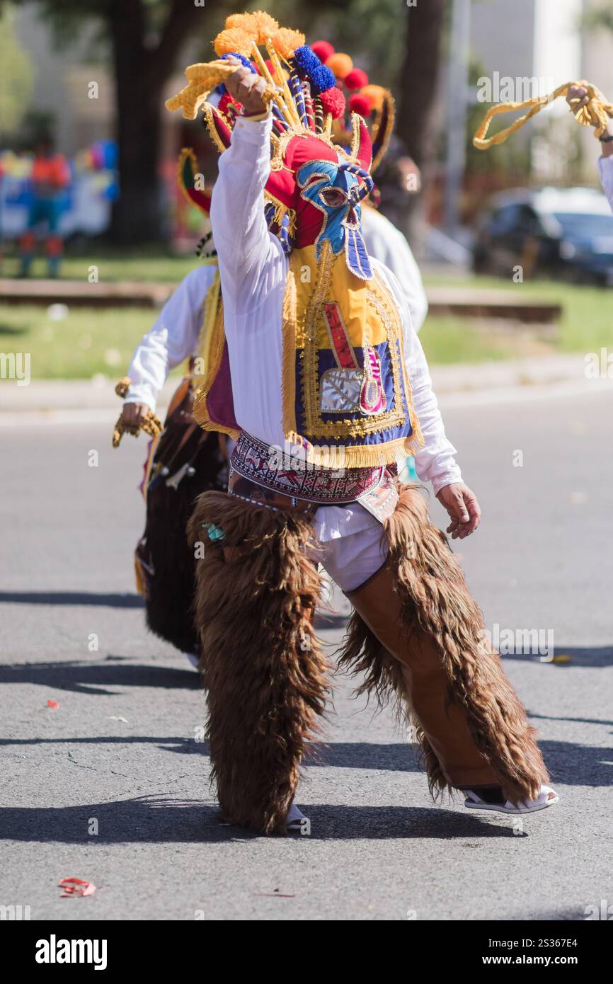 Dancer wearing traditional costume and mask performing at dia de la ...