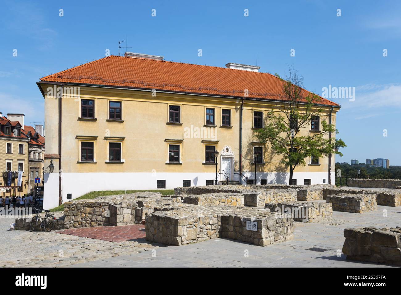Yellow building with red roof, surrounded by historic stone walls, Pod ...