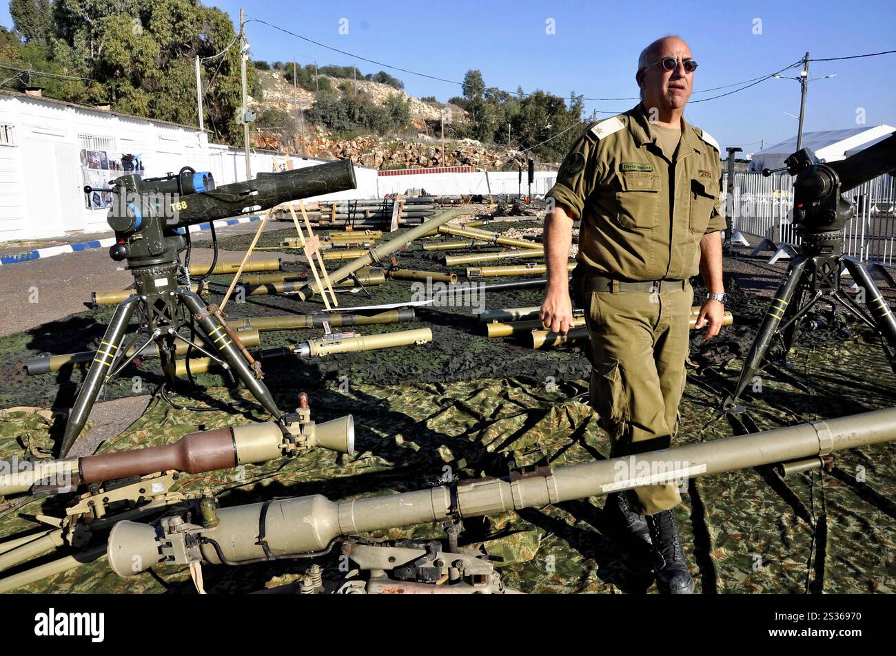 A rocket launcher and other weapons seized from Hezbollah are opened to ...