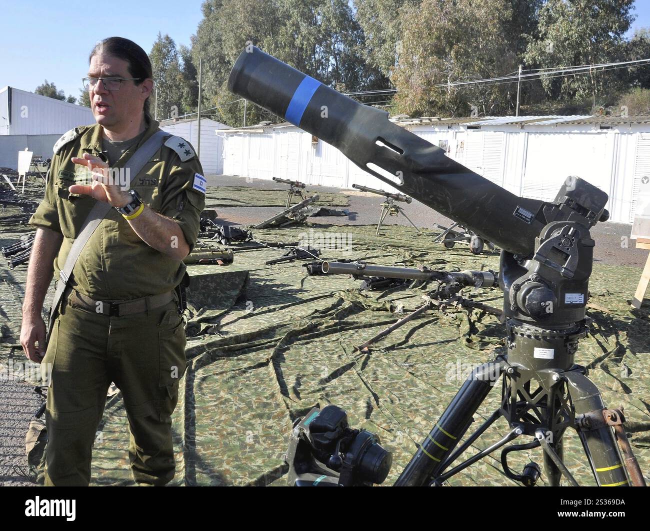 A rocket launcher and other weapons seized from Hezbollah are opened to ...