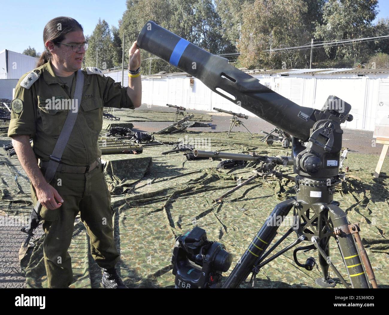 A rocket launcher and other weapons seized from Hezbollah are opened to ...