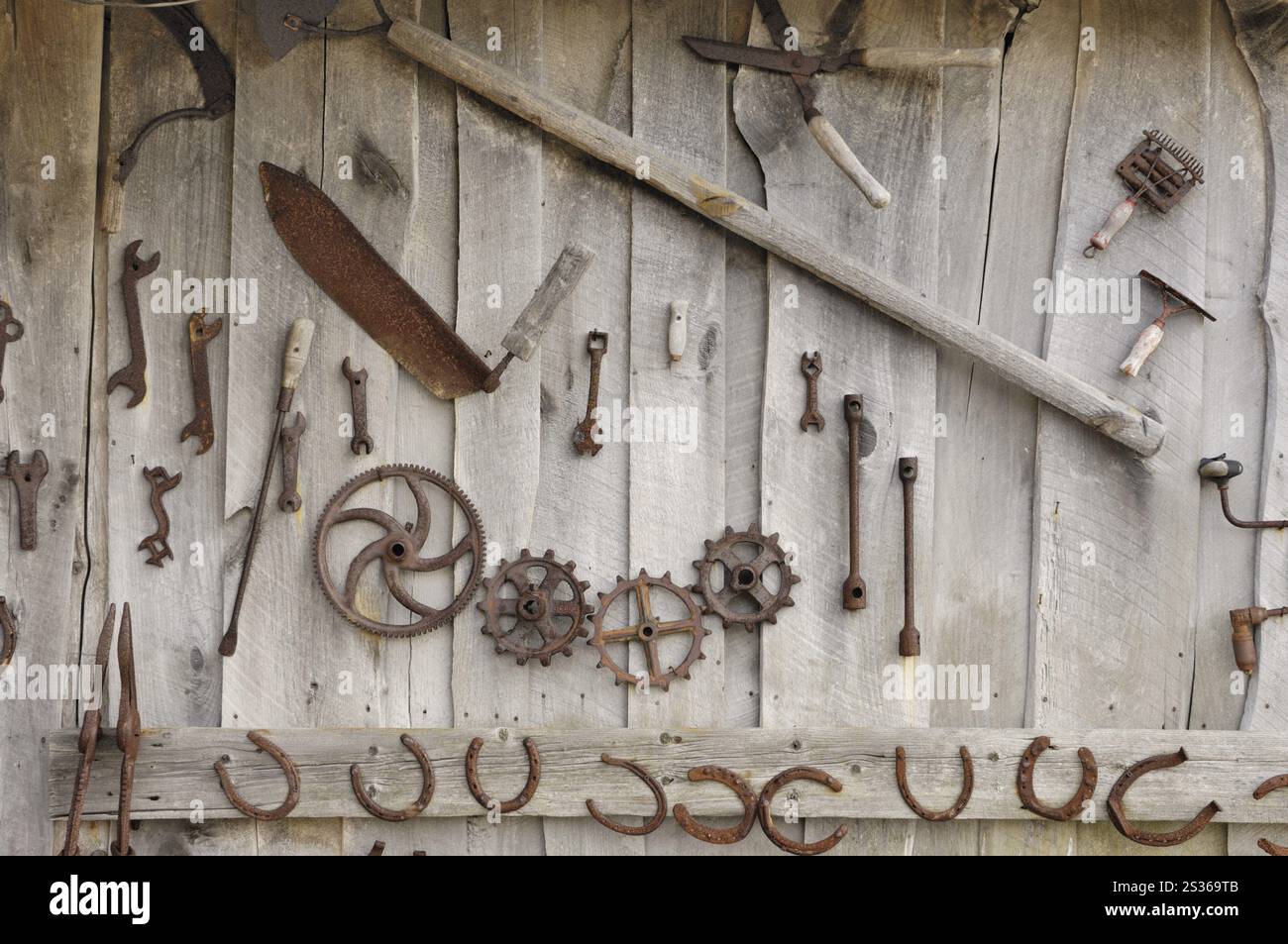 Old rusty tools hanging on a wall Stock Photo - Alamy