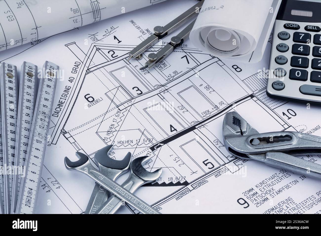 An architect's construction plan with a calculator. Symbolic photo for ...
