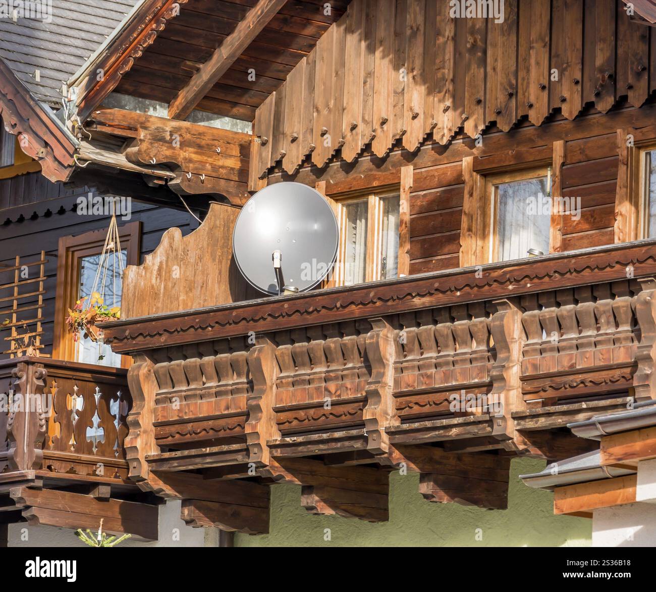 Traditional house with parabolic aerial, symbol of communication, radio ...