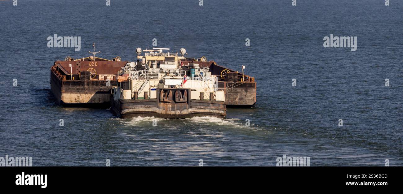 Freighter with bulk goods underway, symbol for shipping, freight ...