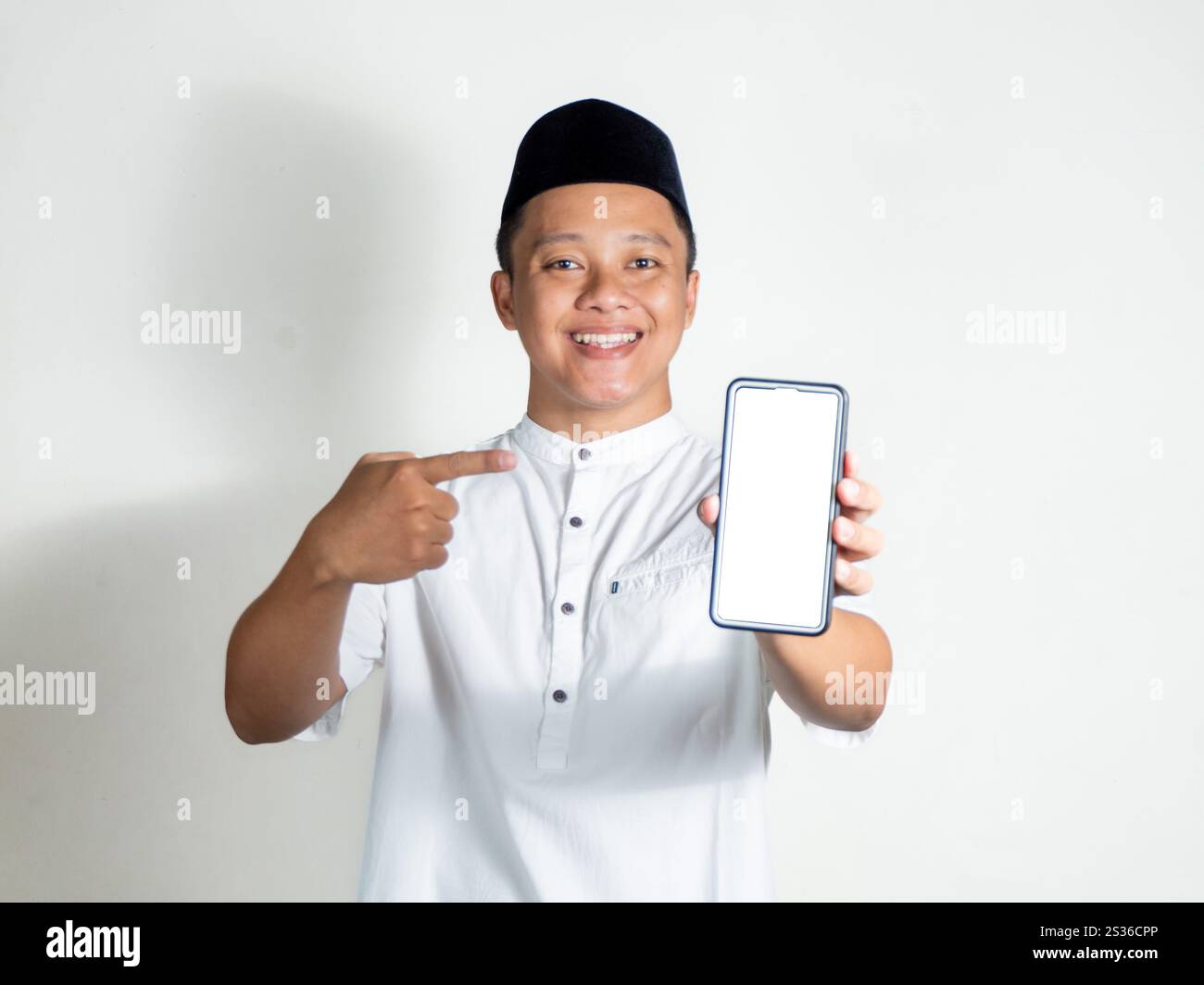 Portrait of Moslem Asian man smiling and showing smartphone blank ...