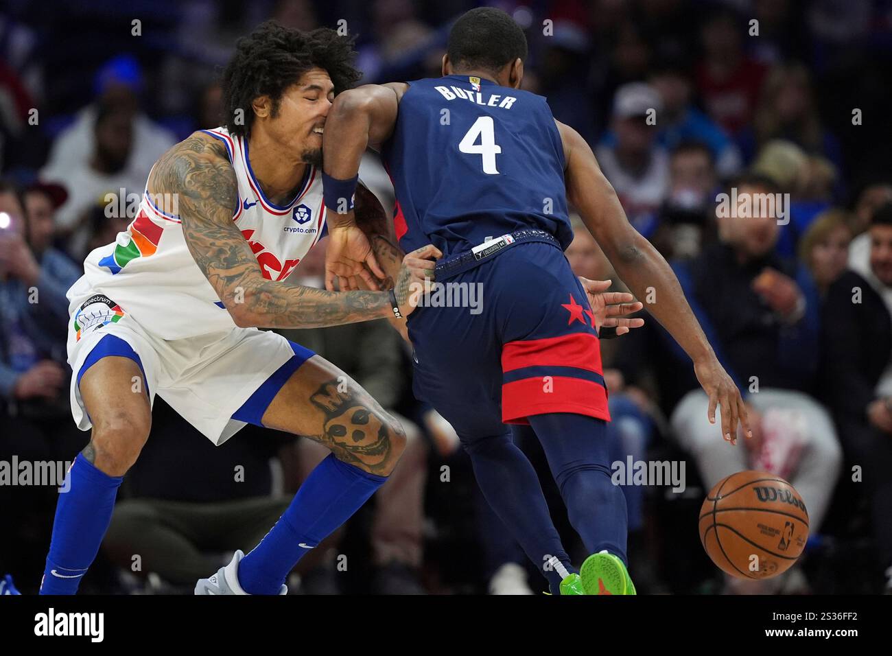 Washington Wizards' Jared Butler, right, collides with Philadelphia ...
