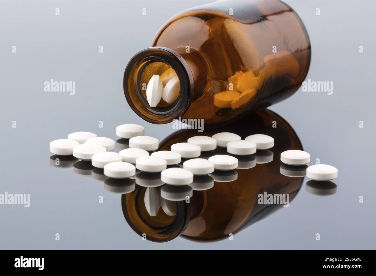 Many tablets with a glass container. Symbolic photo for addiction and ...