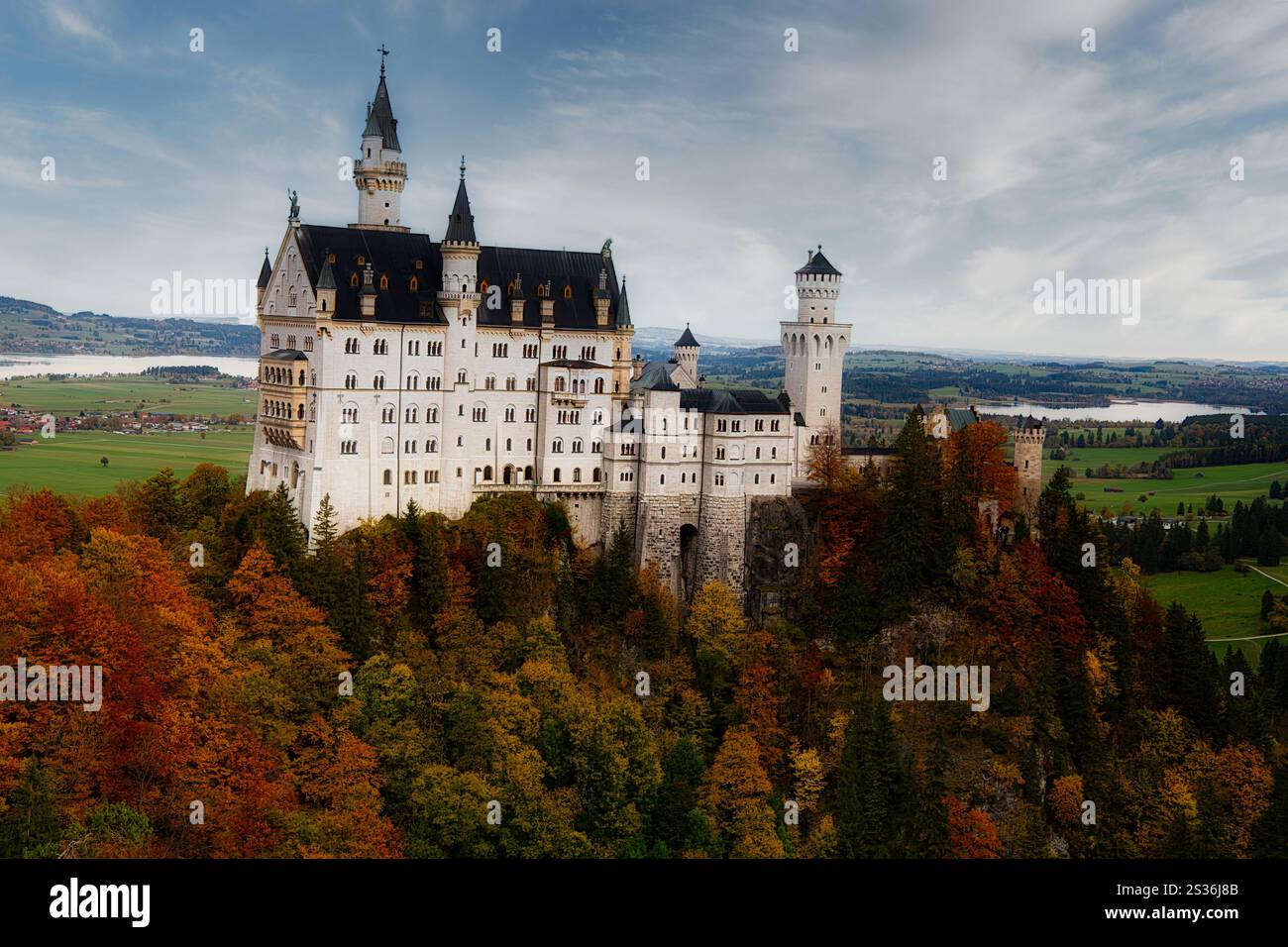 Neuschwanstein Castle surounded by fall colors in Germany Stock Photo ...