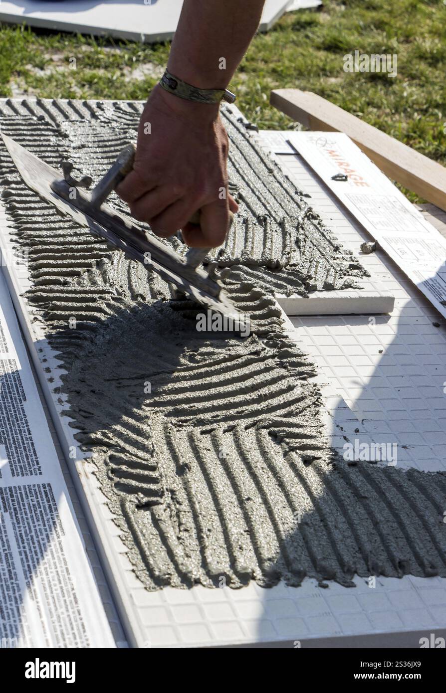 Tiler at work. Tiles are glued. Austria Stock Photo - Alamy