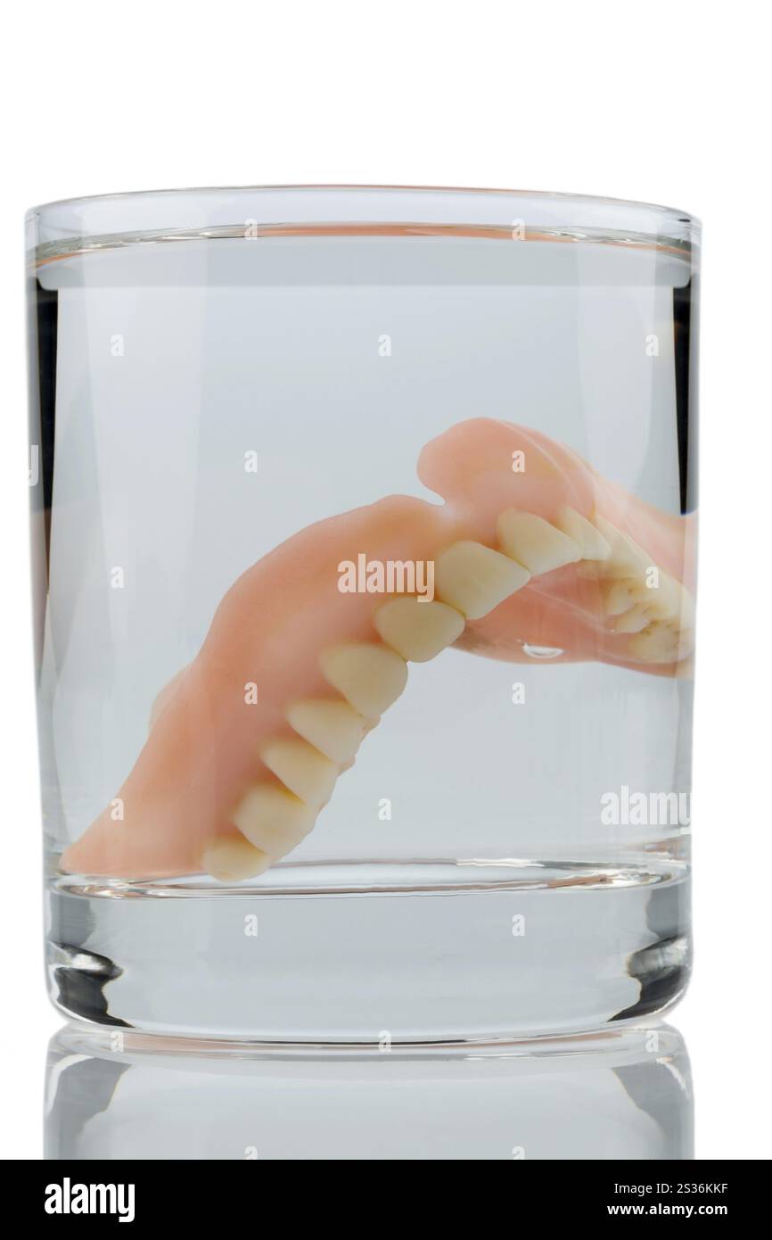 Denture with water glass, symbolic photo for dentures and care Stock ...