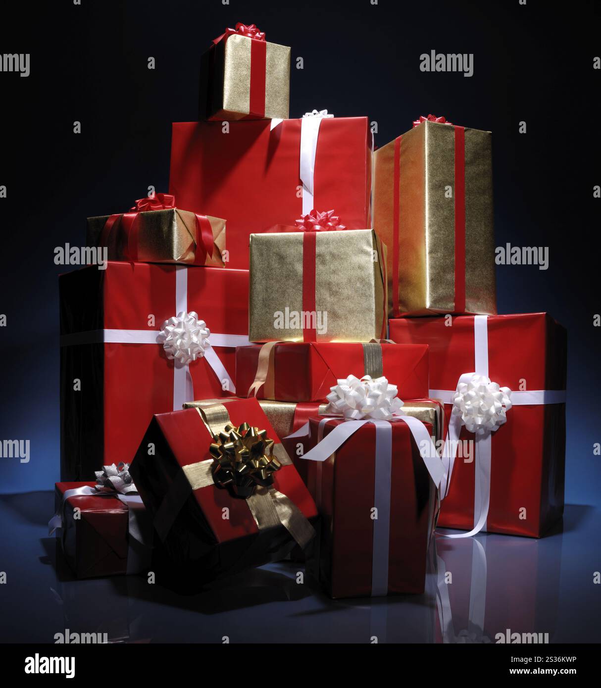 Huge pile of Christmas gift boxes illuminated in darkness isolated on ...