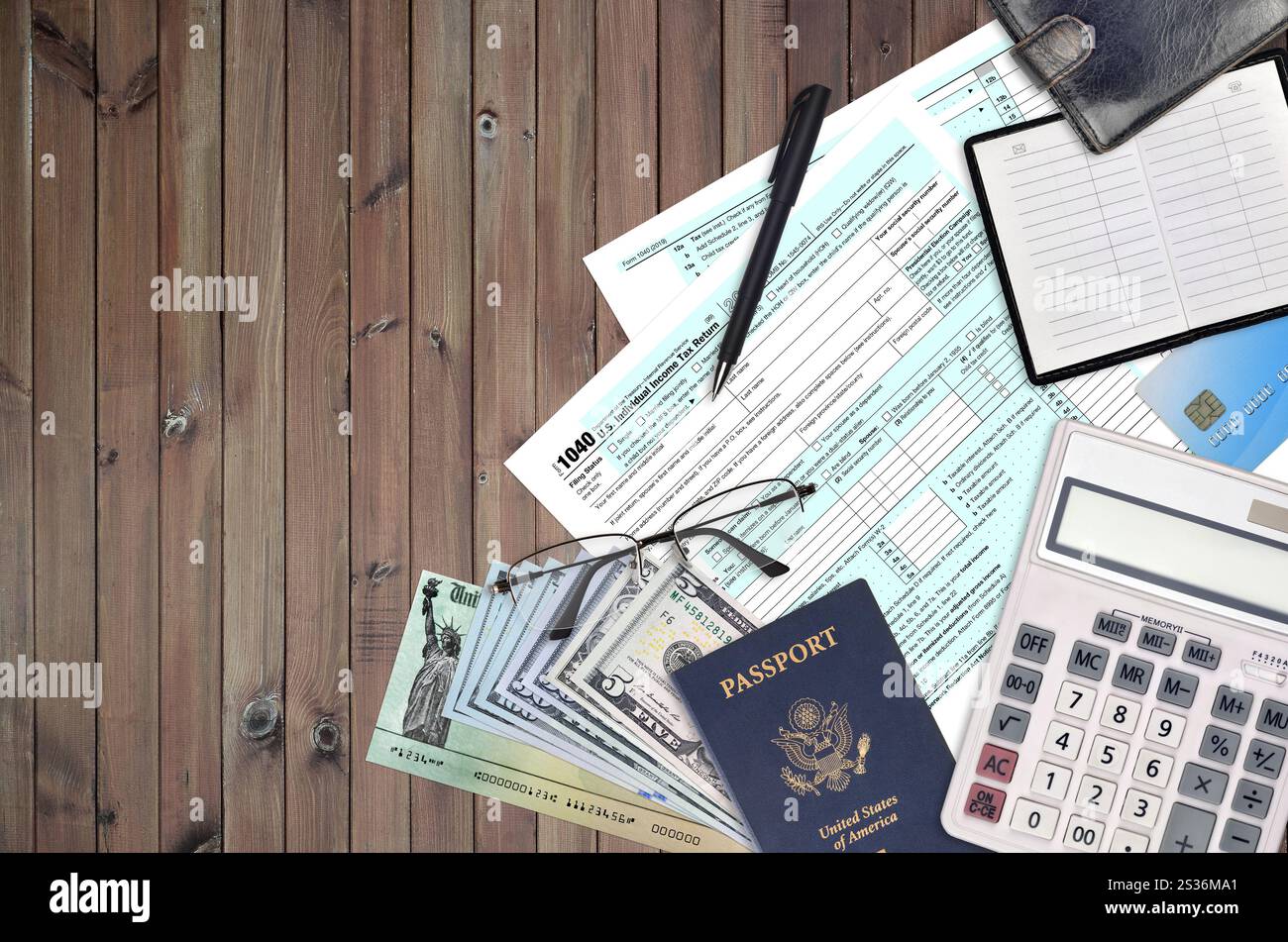 IRS form 1040 U.S. Individual income tax return with refund check lies ...