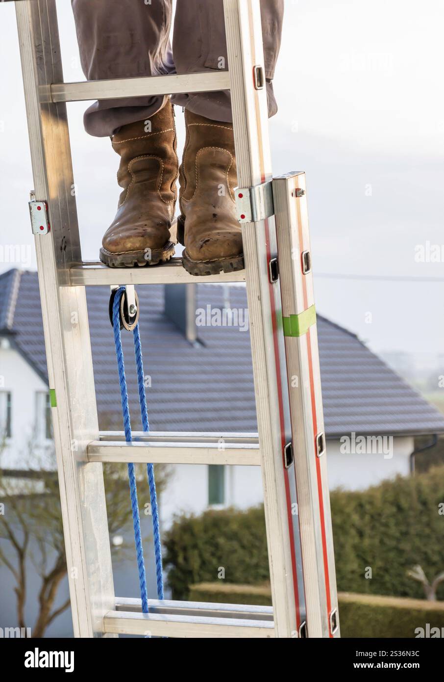 Craftsman on a ladder at the house, symbol for craft, renovation ...