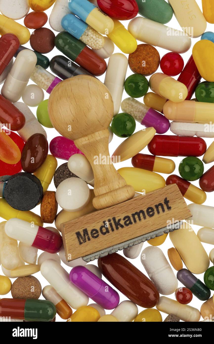 Stamp on coloured tablets, symbol photo for drug therapy and ...