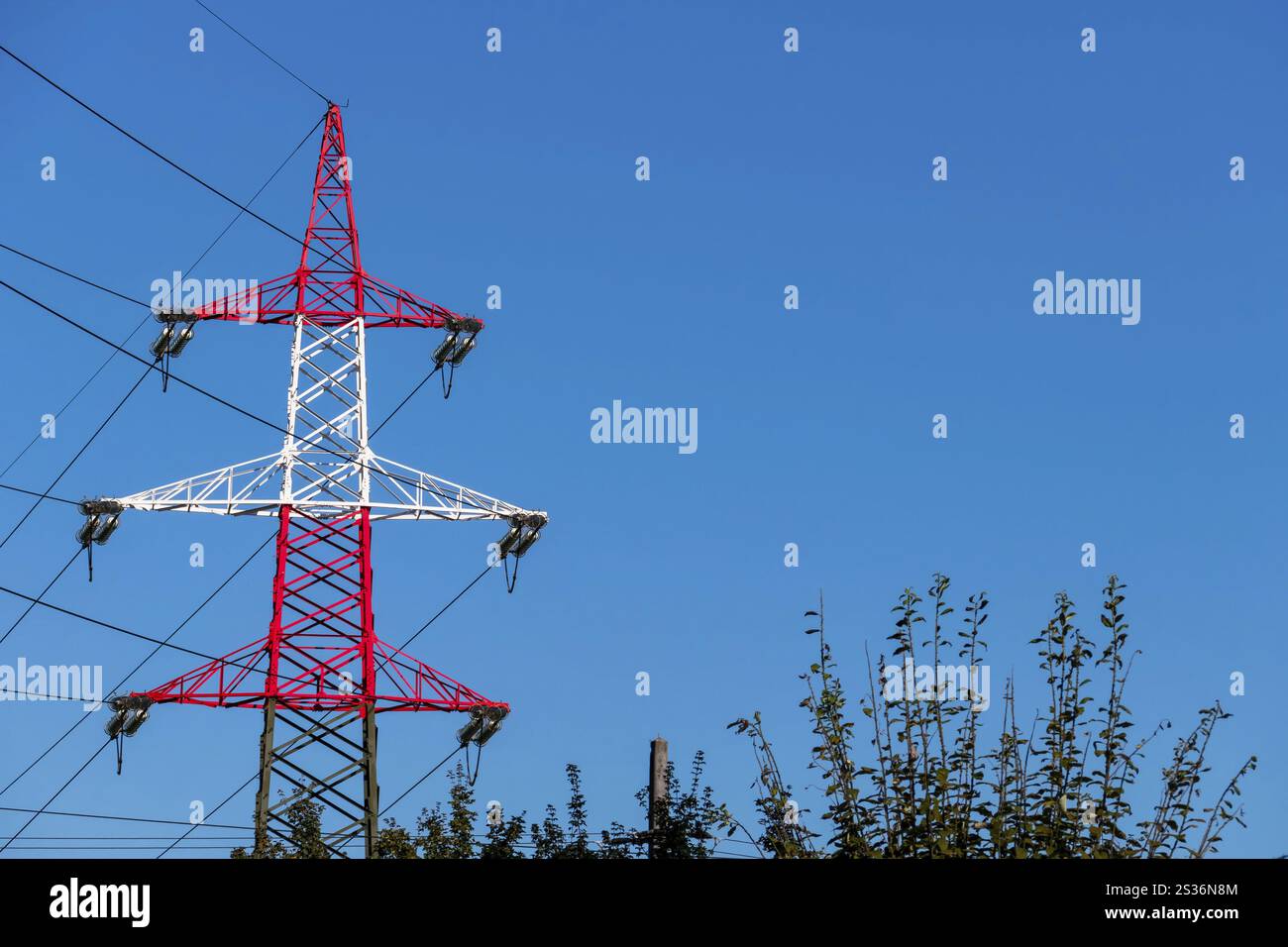 High-voltage pylon red and white, symbol for electricity, power supply ...