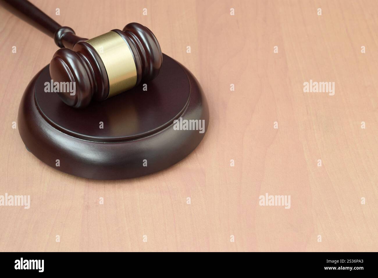 Justice mallet on wooden desk in a courtroom during a judicial trial. Law concept and empty copy ...