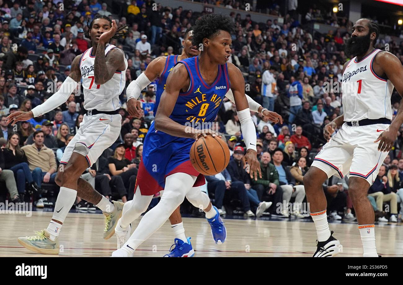 Denver Nuggets forward Peyton Watson, center, drives the baseline as ...