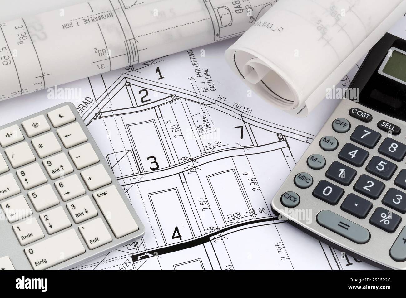 An architect's construction plan with a calculator. Symbolic photo for ...