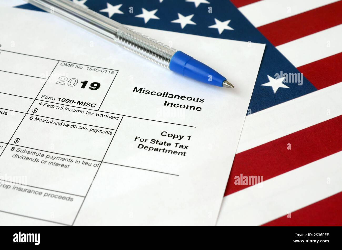 Form 1099-misc Miscellaneous income and blue pen on United States flag ...