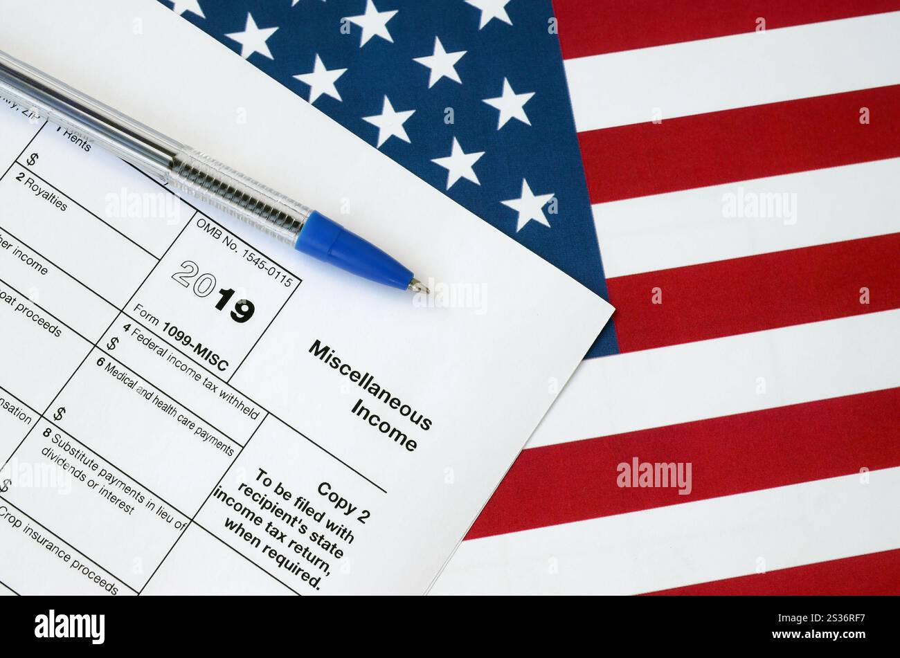 Form 1099-misc Miscellaneous income and blue pen on United States flag ...