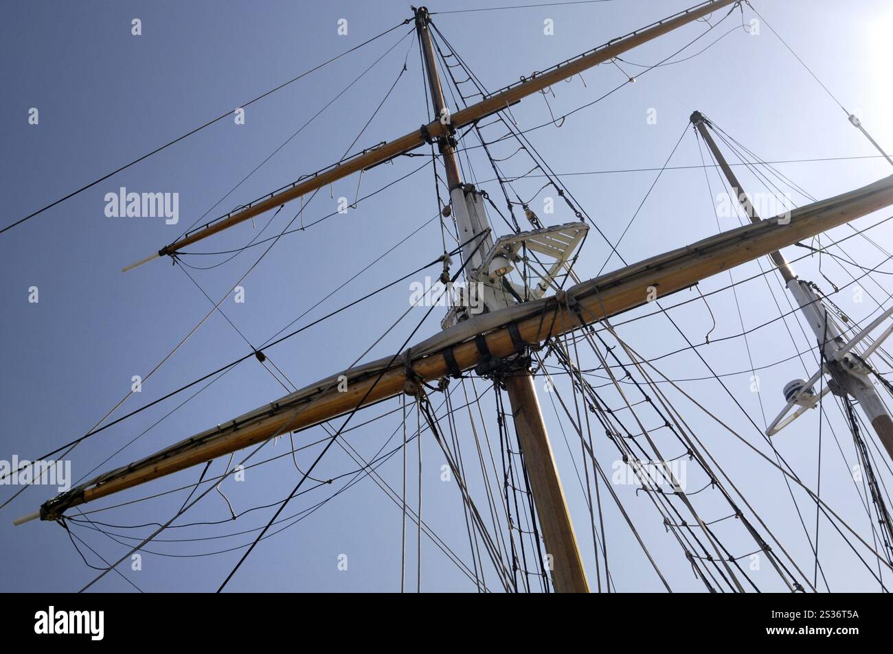 Closeup of a sailing vessel mast with square rig over blue sky Stock ...