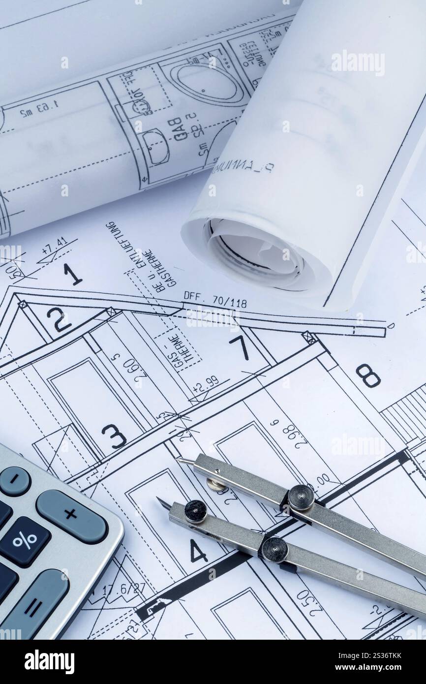 An architect's construction plan with a calculator. Symbolic photo for ...