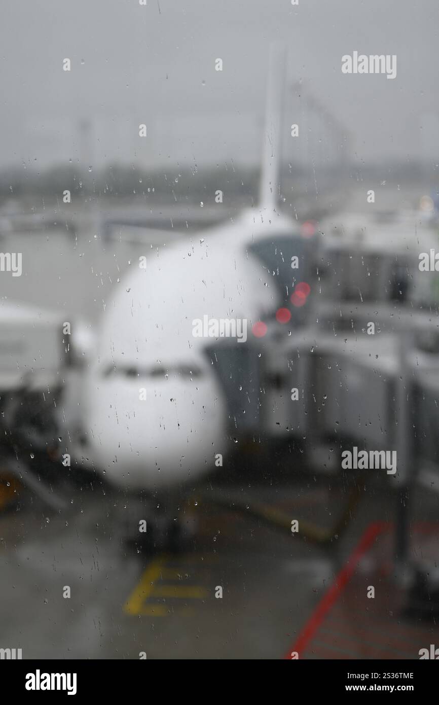 Lufthansa Airbus A380-800 in the rain at the check-in position, raindrops on the window ...