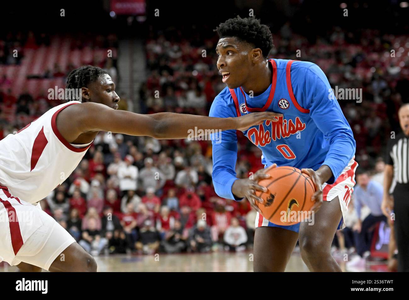 Mississippi forward Malik Dia (0) tires to shoot over Arkansas forward ...
