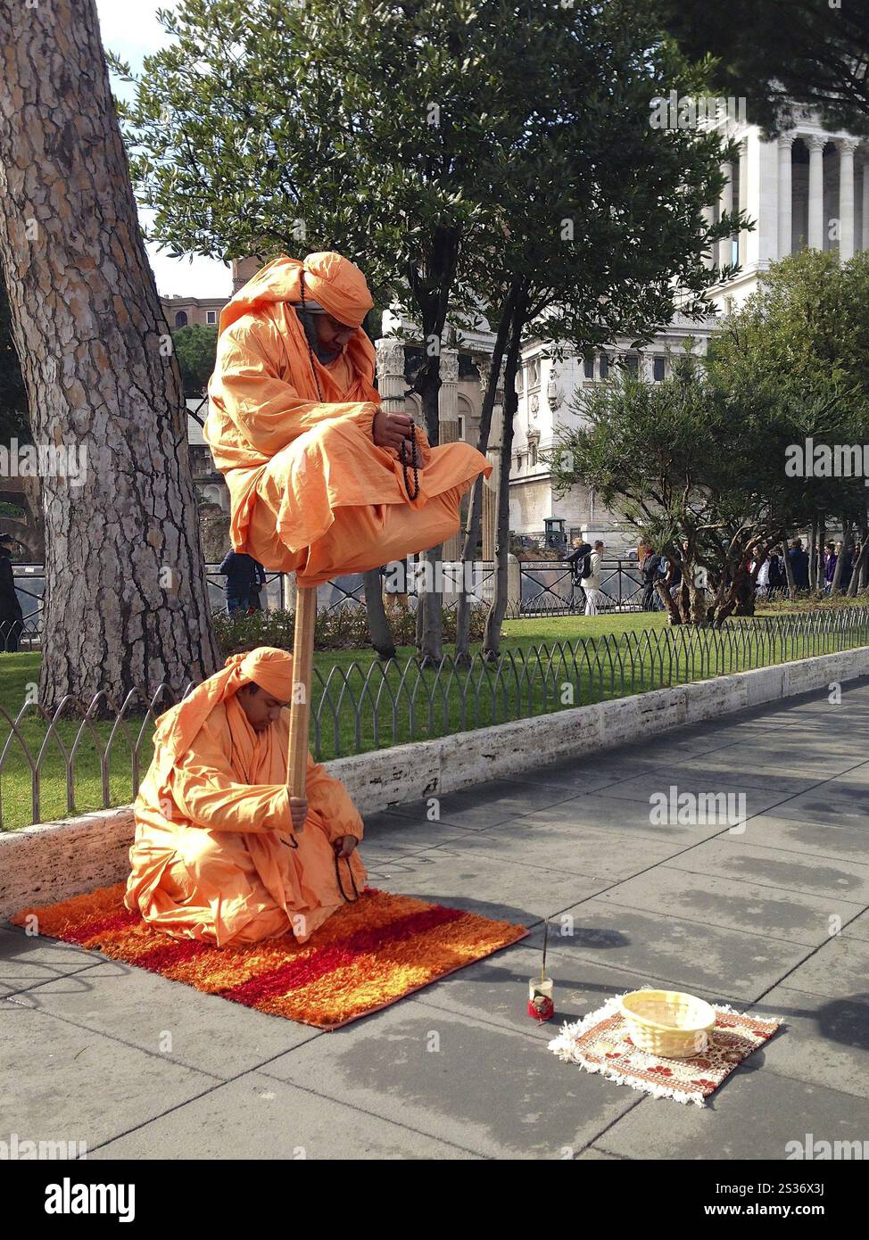 Orange-clad mendicants on the streets of Rome Stock Photo - Alamy