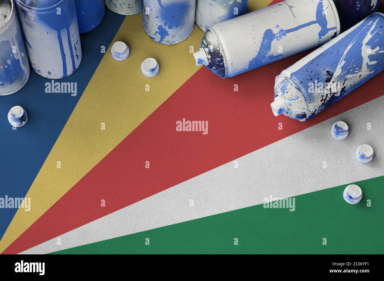Seychelles flag and few used aerosol spray cans for graffiti painting ...
