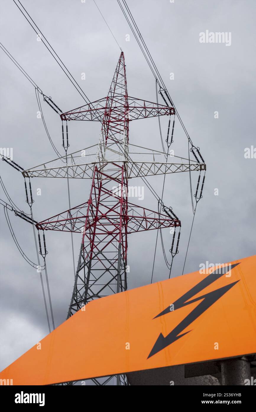 The pylon of a high-voltage power line in front of dark clouds. Austria ...
