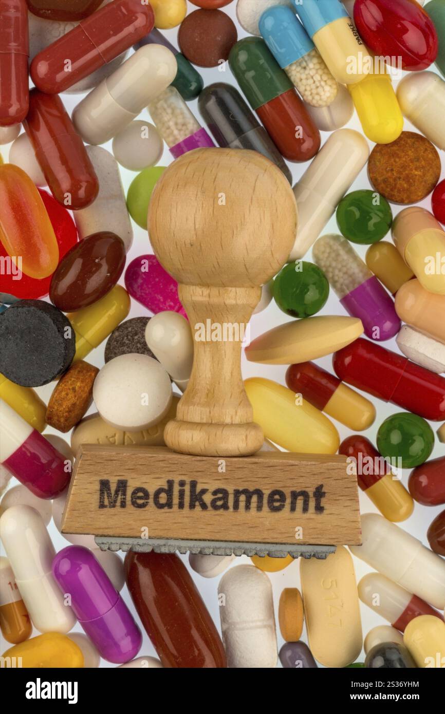 Stamp on coloured tablets, symbol photo for drug therapy and ...