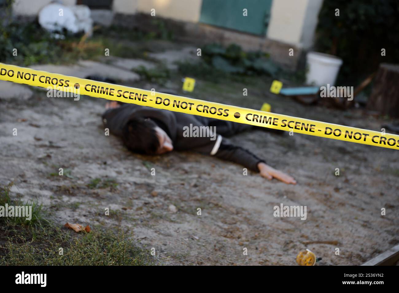 Victim of a violent crime in a backyard of residental house in evening ...