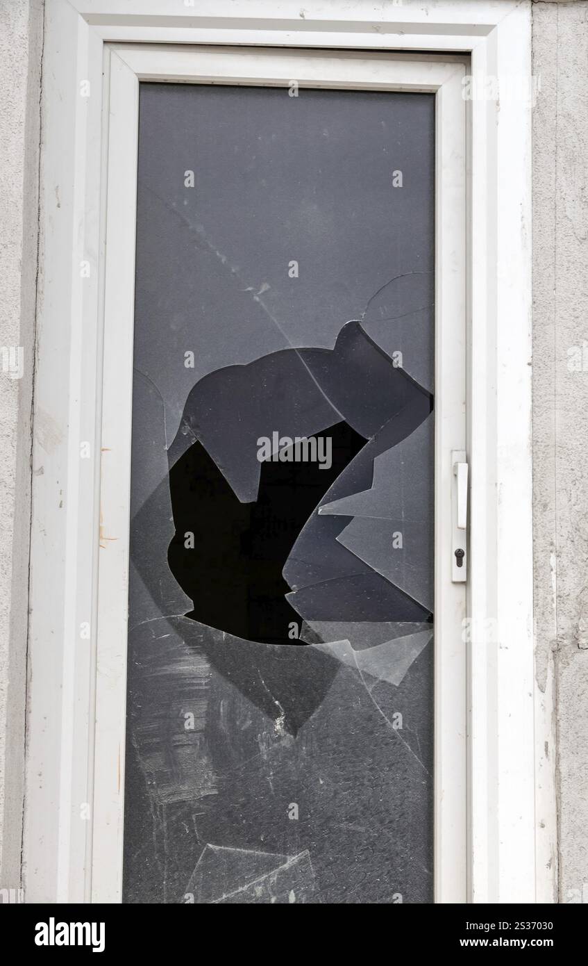 A broken window pane on a patio door Austria Stock Photo - Alamy