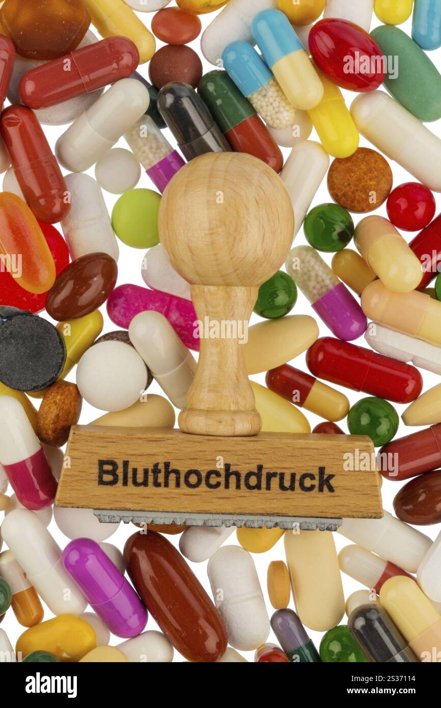 Stamp on colourful tablets, symbolic photo for high blood pressure ...