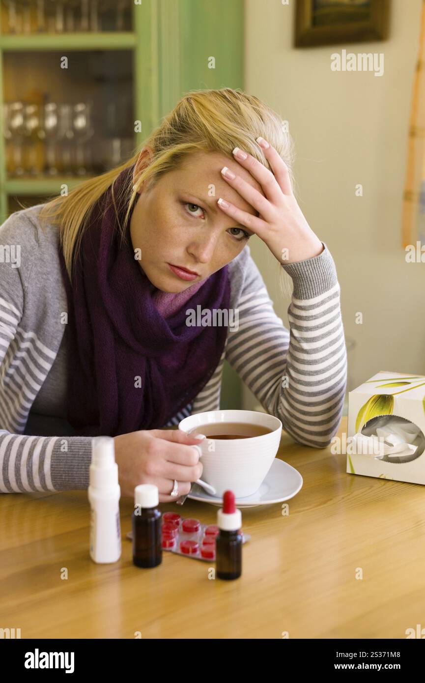 Woman on sick leave with tea and medication. Colds, sniffles and flu ...