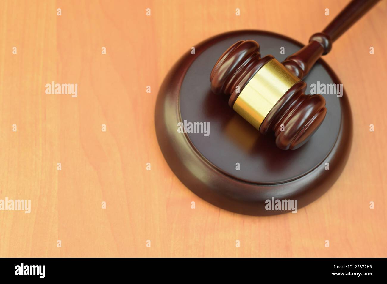 Justice mallet on wooden desk in a courtroom during a judicial trial. Law concept and empty copy ...
