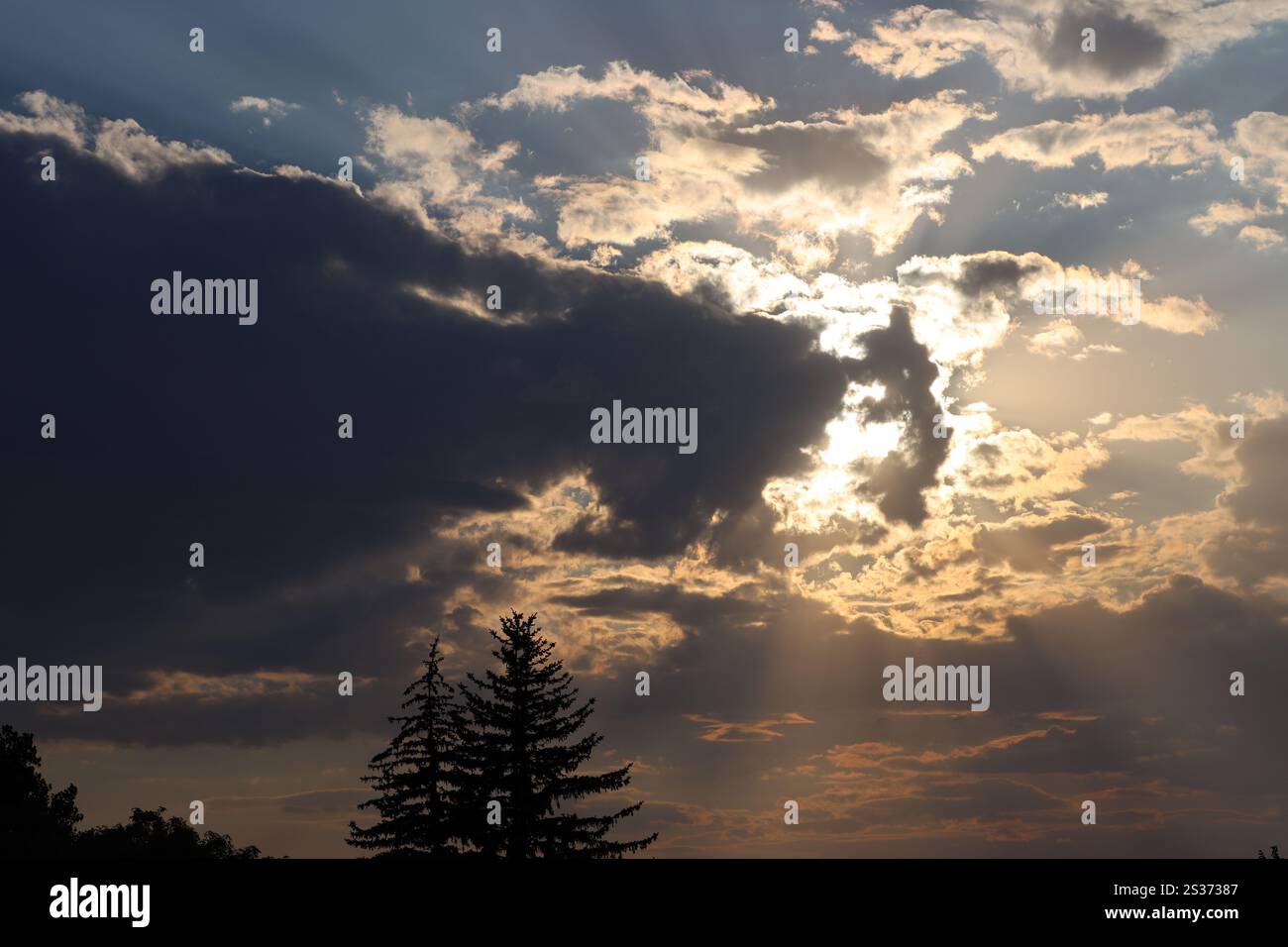 sun reappearing from behind heavy dark clouds Stock Photo - Alamy