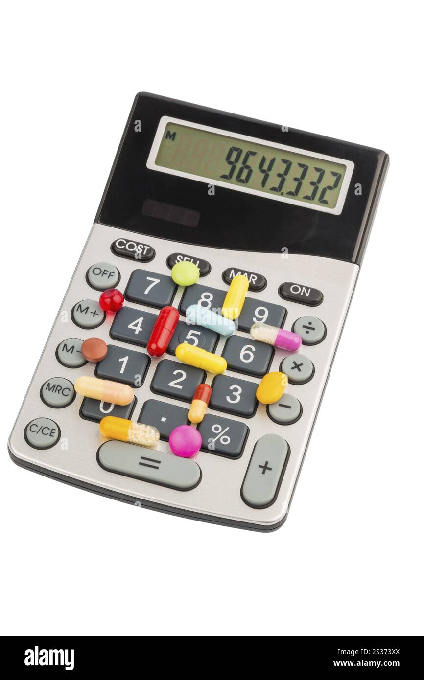 Tablets lying on a calculator. Symbol photo for costs in the medical ...