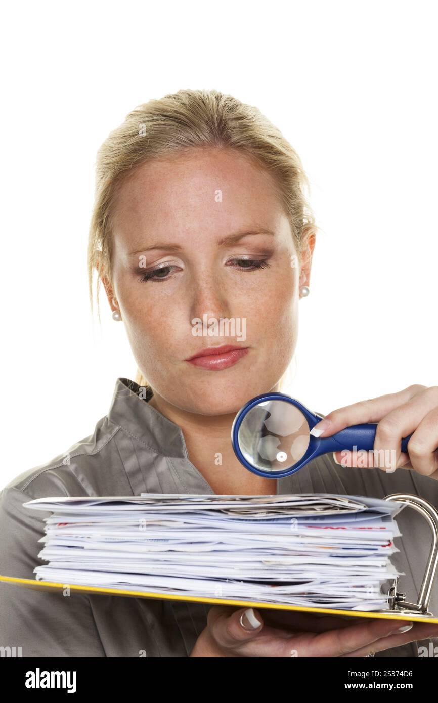 A tax auditor from the tax office at work. Auditor examines documents ...