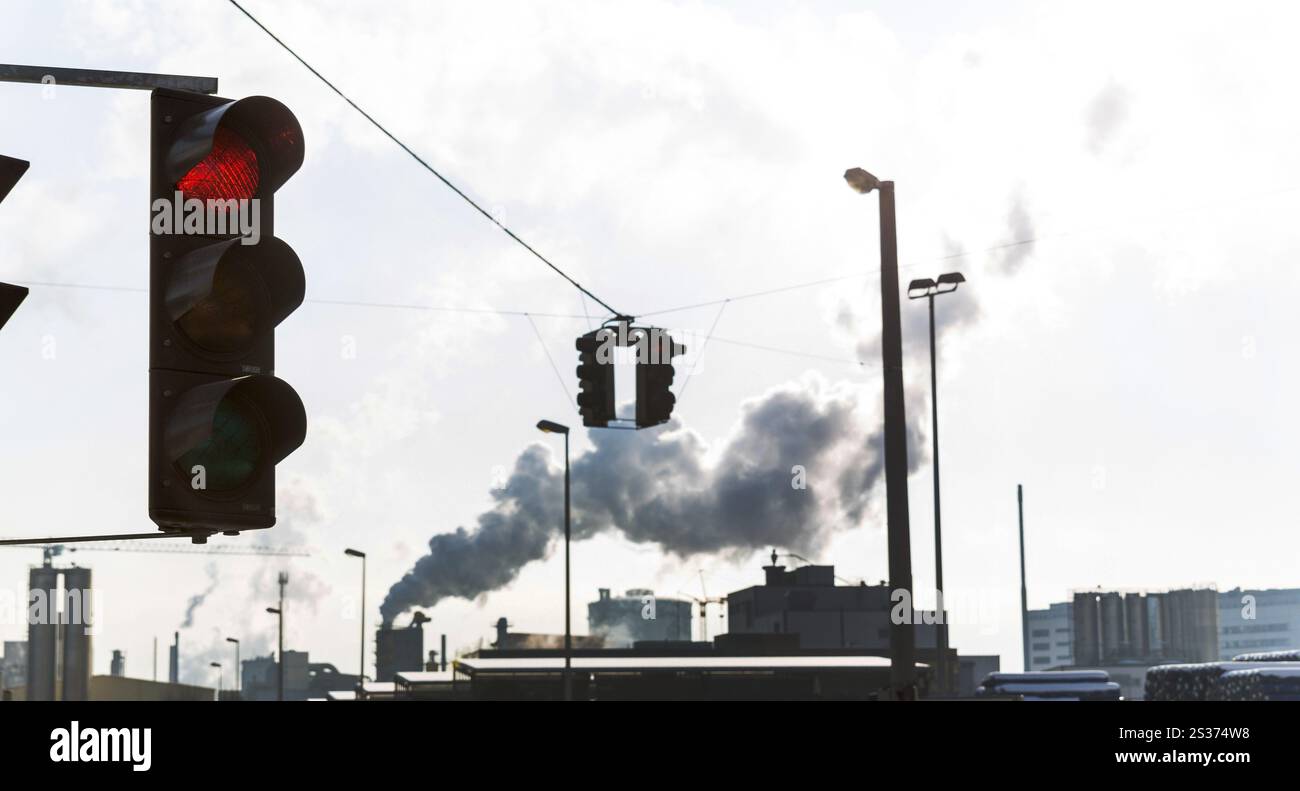 Industrial plant chimney and red traffic light. Symbolic photo for ...