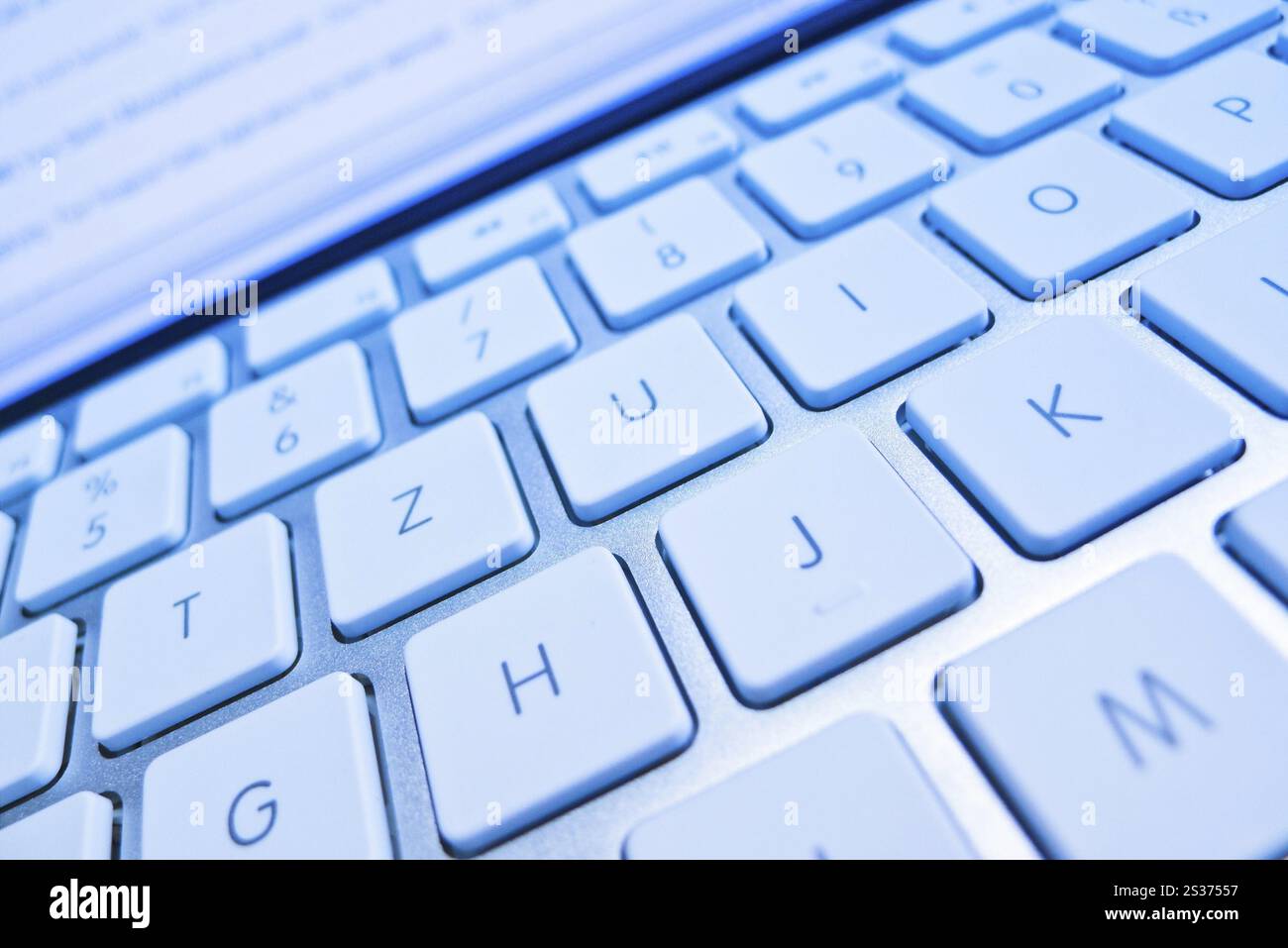 The keyboard of a computer in front of a screen. Data processing and ...