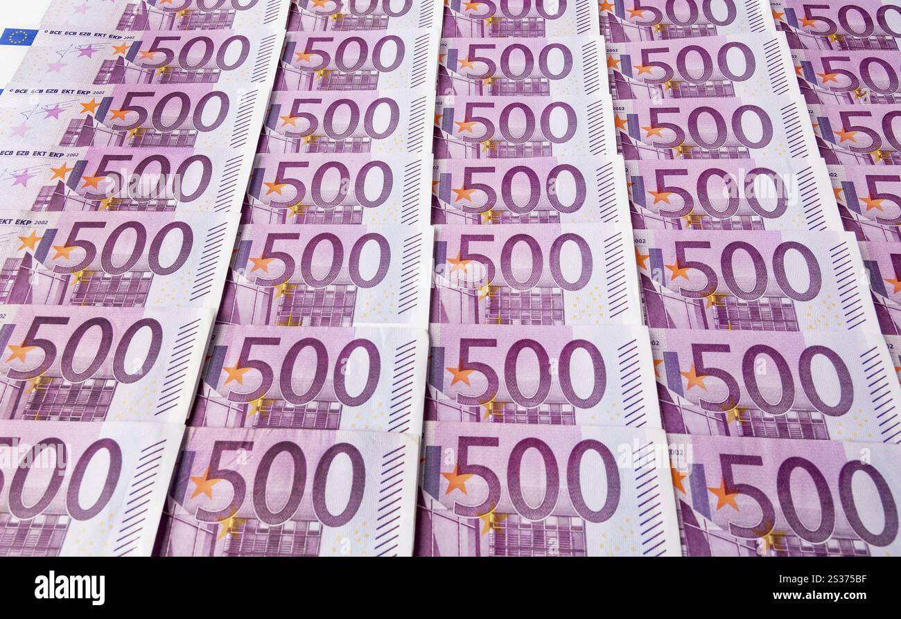 Many five hundred euro banknotes lying next to each other. Symbolic ...