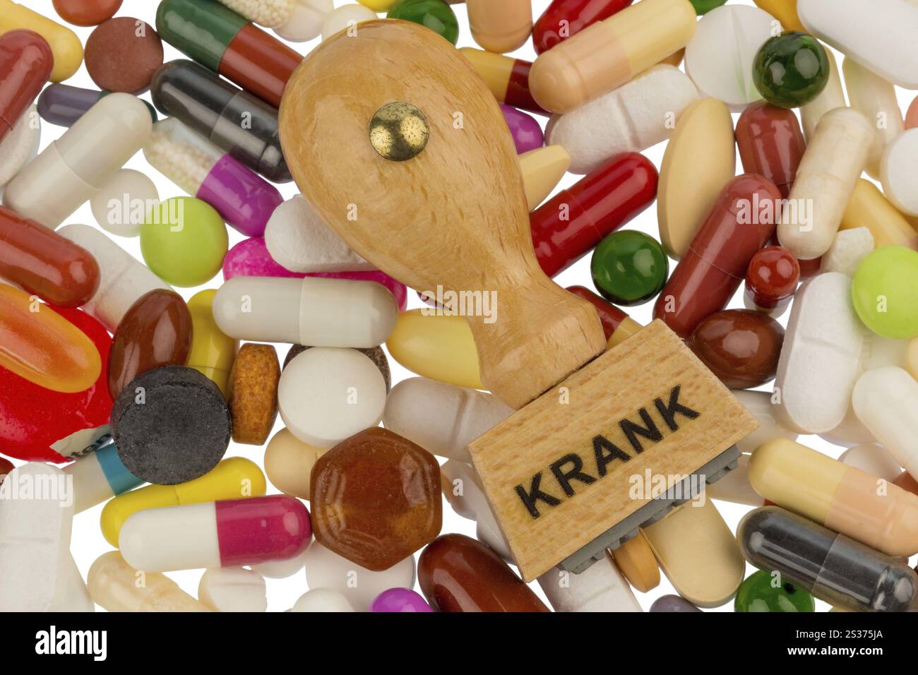 Stamp on colourful tablets, symbolic photo for illness, sick note and ...
