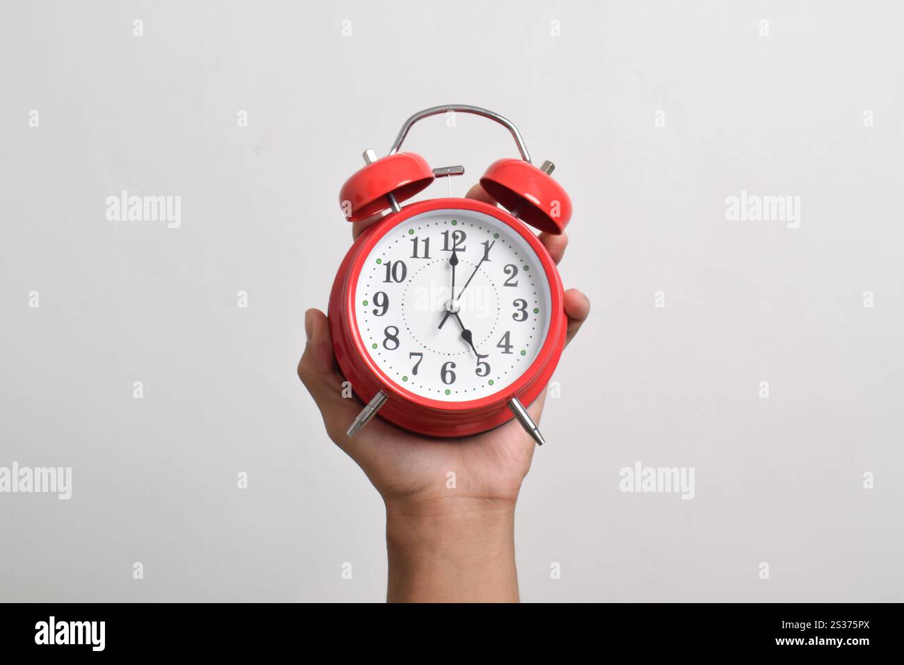 Vintage red alarm clock in hand. Round red alarm clock isolated on ...