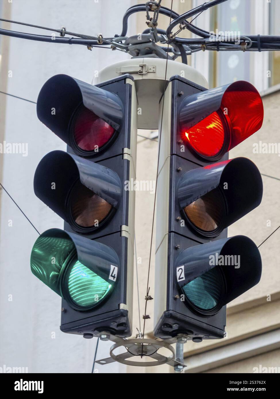 A traffic light with red and green light at a junction Stock Photo - Alamy
