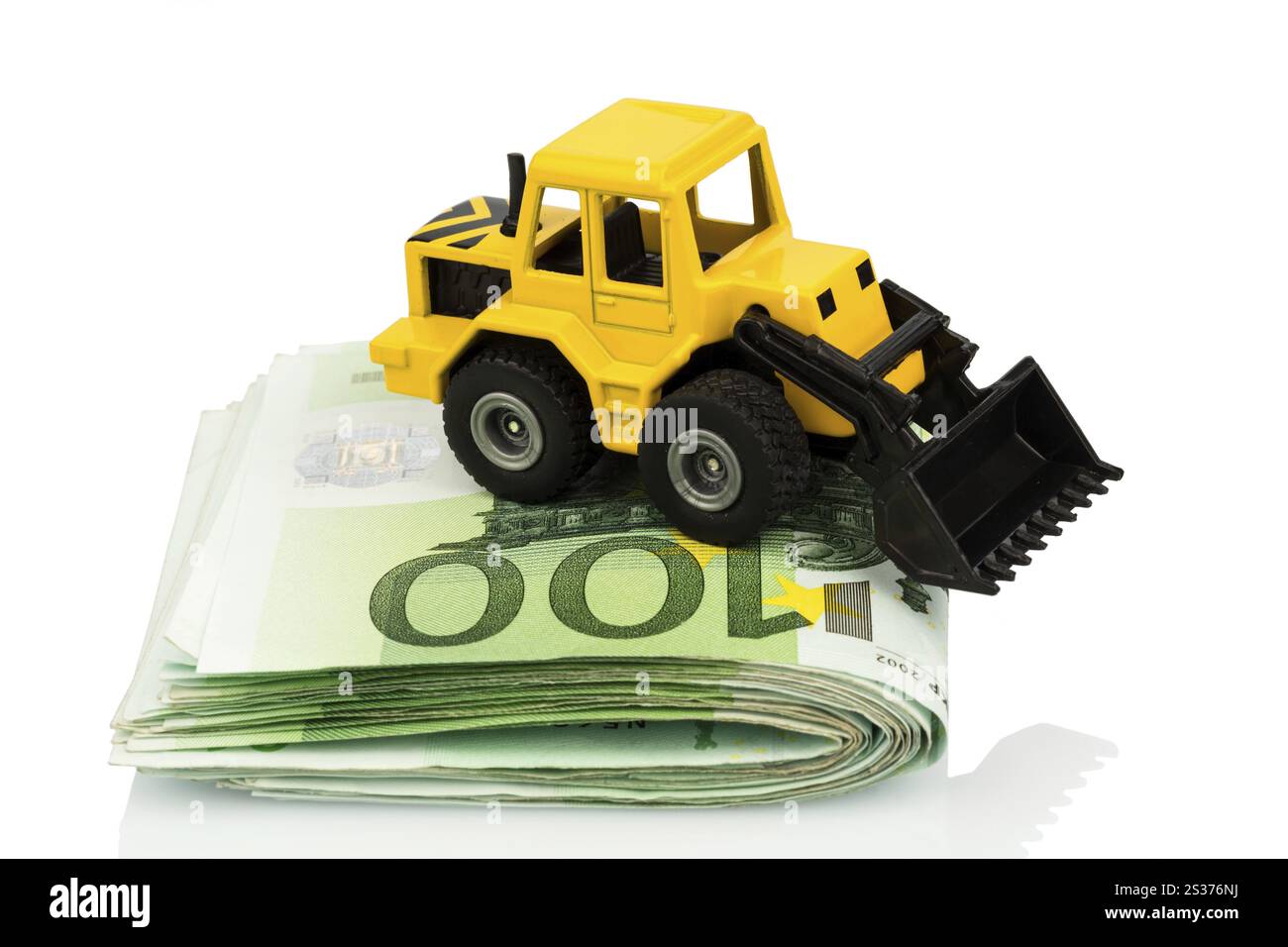An excavator stands on euro banknotes. Symbol photo for costs, income ...