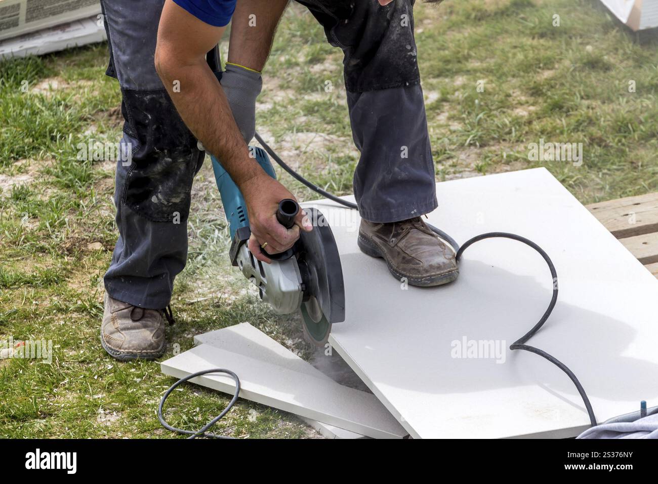 A tiler at work. Cutting tiles with a cutting disc Austria Stock Photo ...